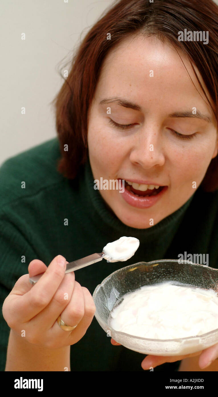 Woman eats yogurt spoon hi-res stock photography and images - Alamy