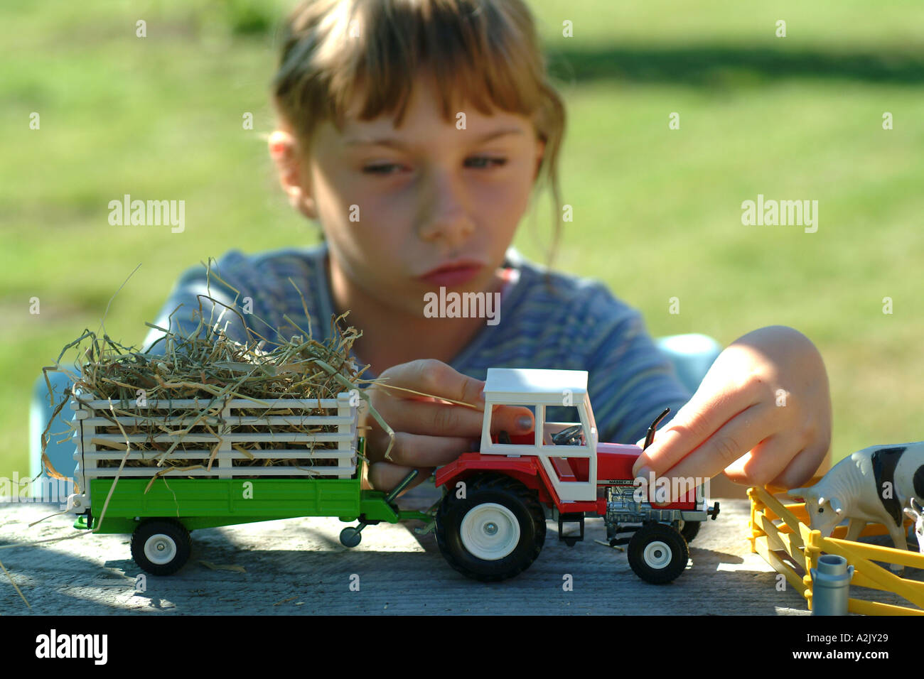 child plays with farm machine Stock Photo - Alamy