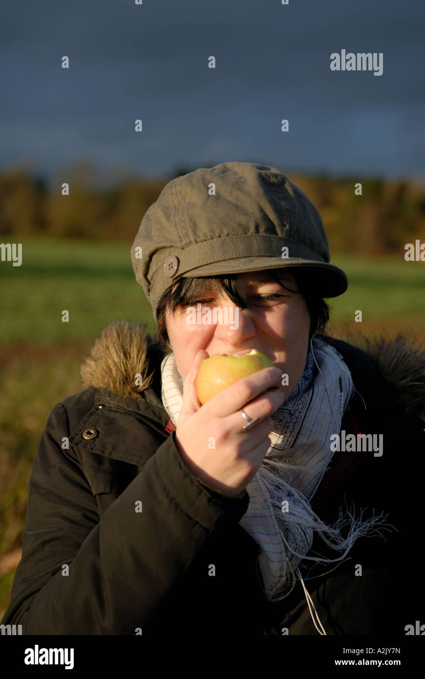 Teenager eating sour Apple Stock Photo - Alamy