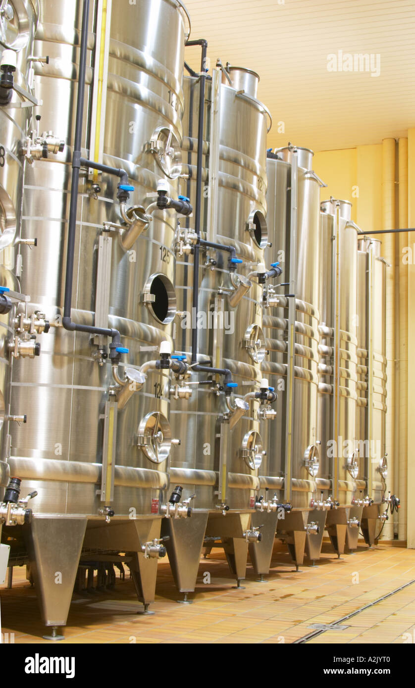 Stacks of stainless steel fermentation vats in various sizes and with ...