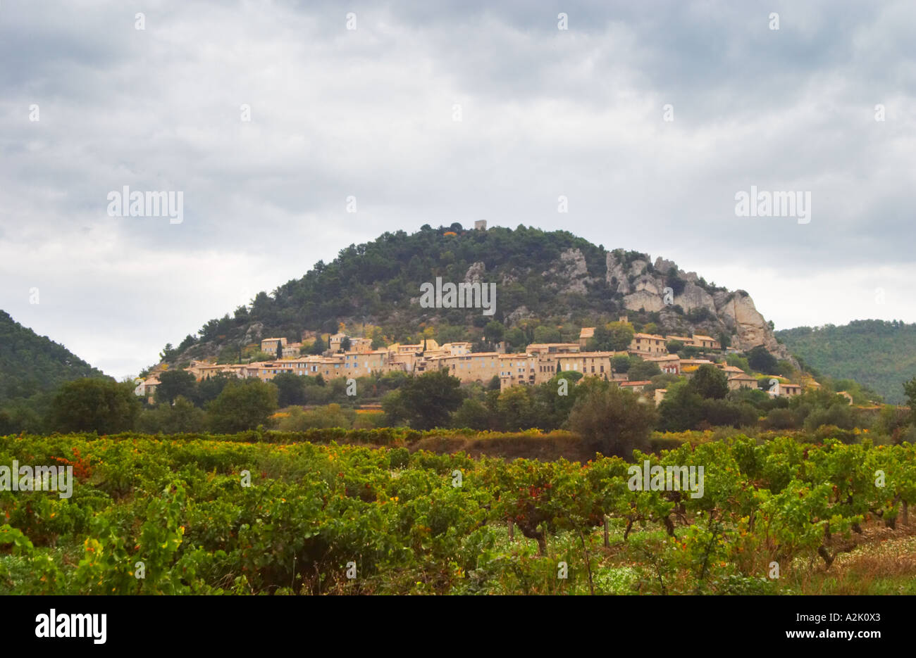 The Seguret village clinging to the hillside, viewed over a vineyard ...