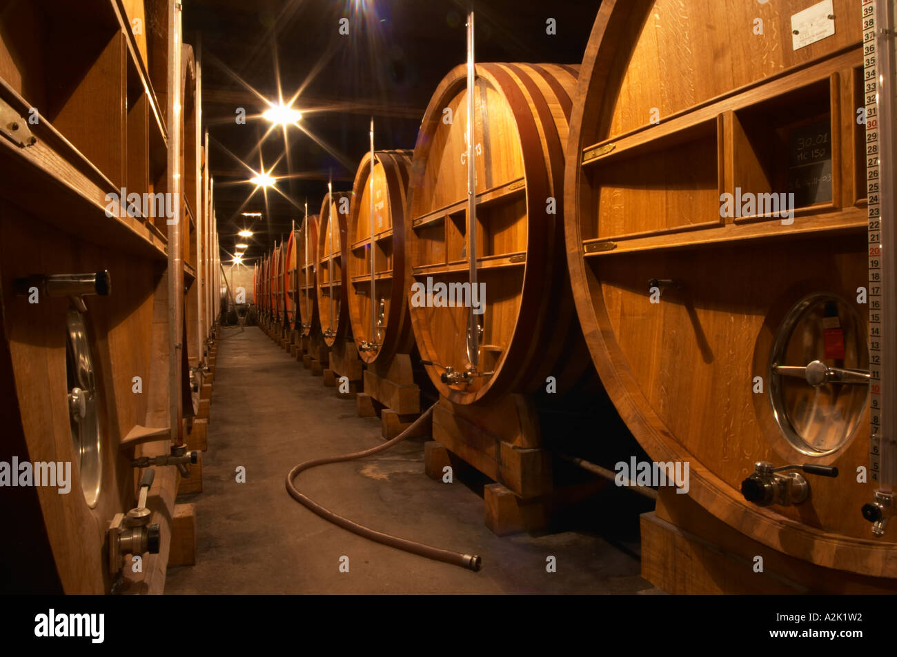 Wooden storage vats with aging wine in the cellar of Guigal in Ampuis ...