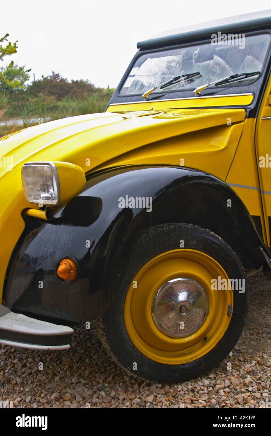 An old black and yellow Citroen 2CV 2 CV, detail of the front left side ...