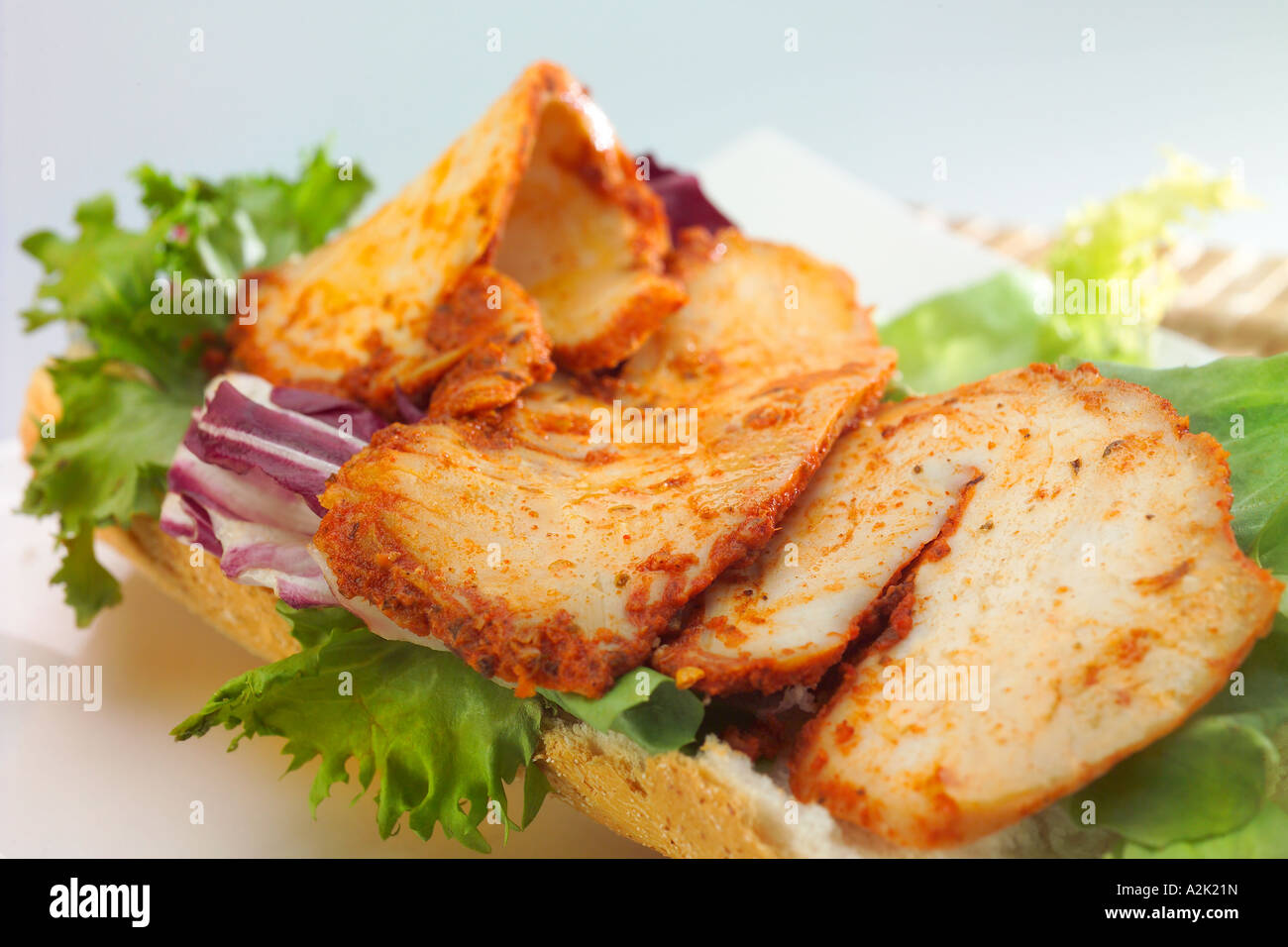 Slices of Chicken Tikka served on open Baguette with salad Stock Photo ...
