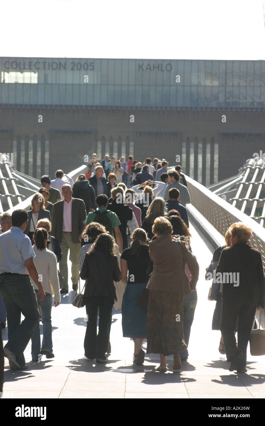 People walking over Millennium Bridge to Tate Modern London UK Stock ...