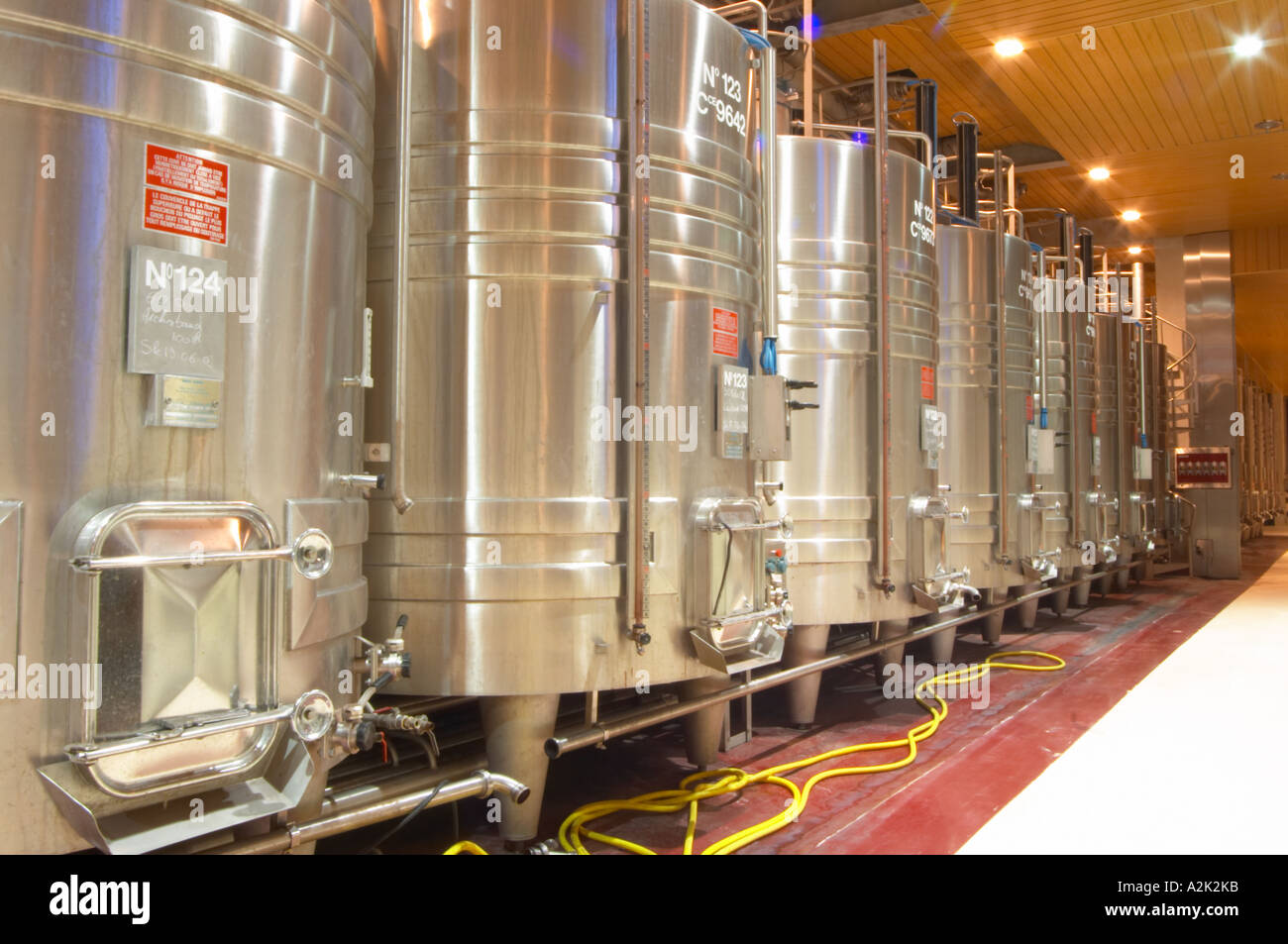 Stainless steel fermentation tanks in the winery of Guigal. Domaine E ...