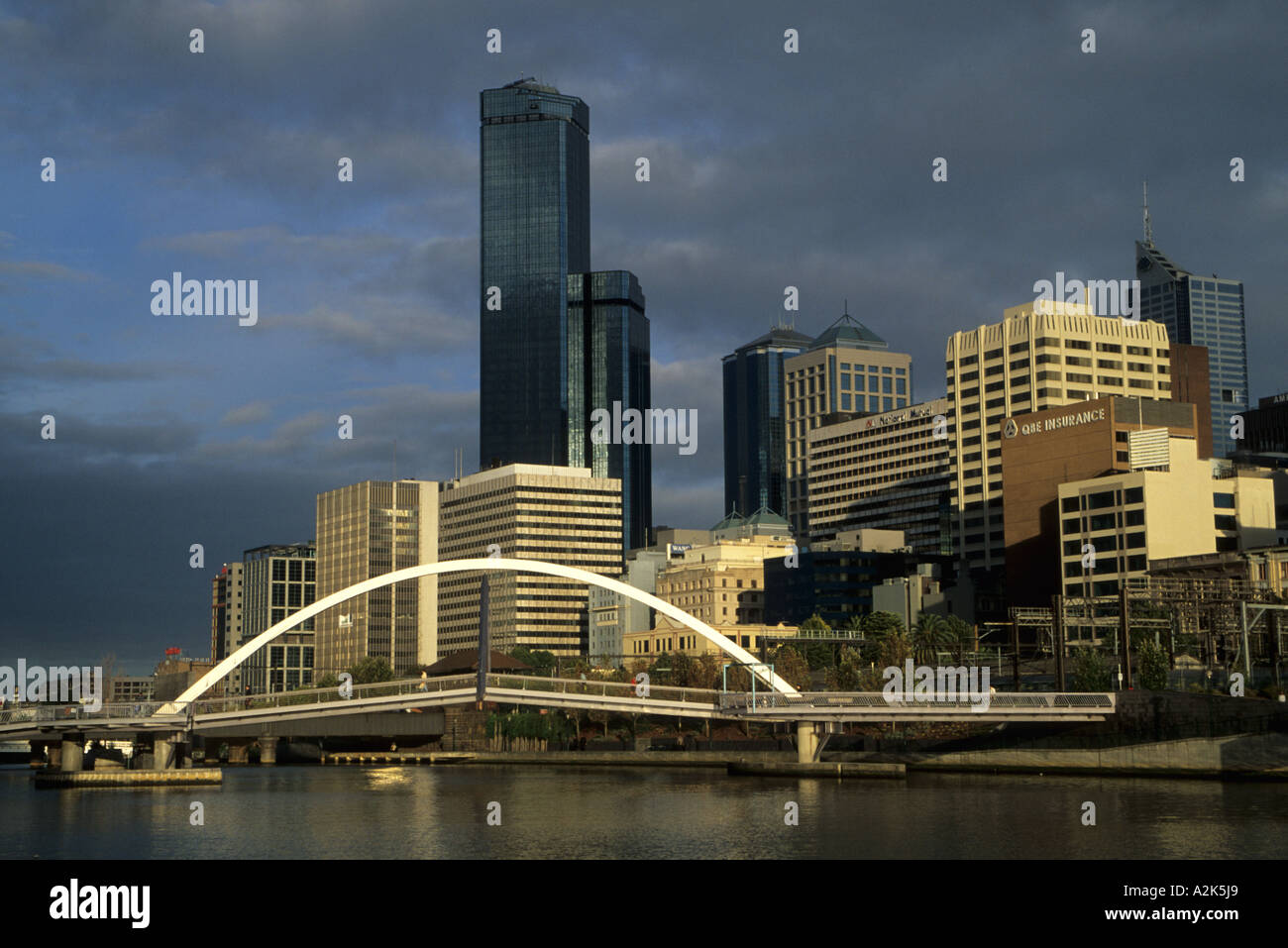 Australia, Melbourne. City skyline with pedestrian bridge arched over ...