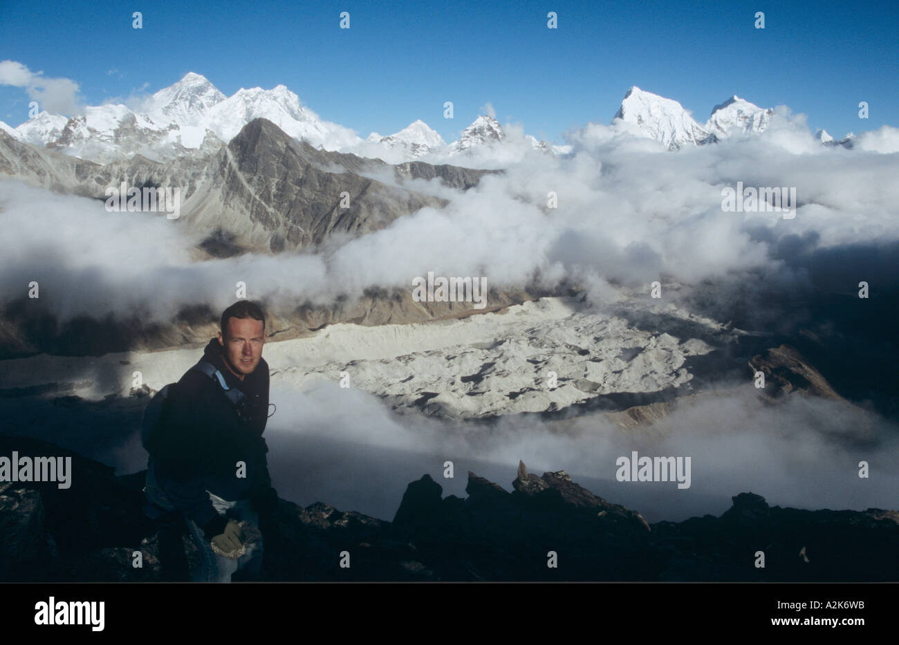 Nepal, The photographer at the summit of Gokyo Ri with Everest in the ...