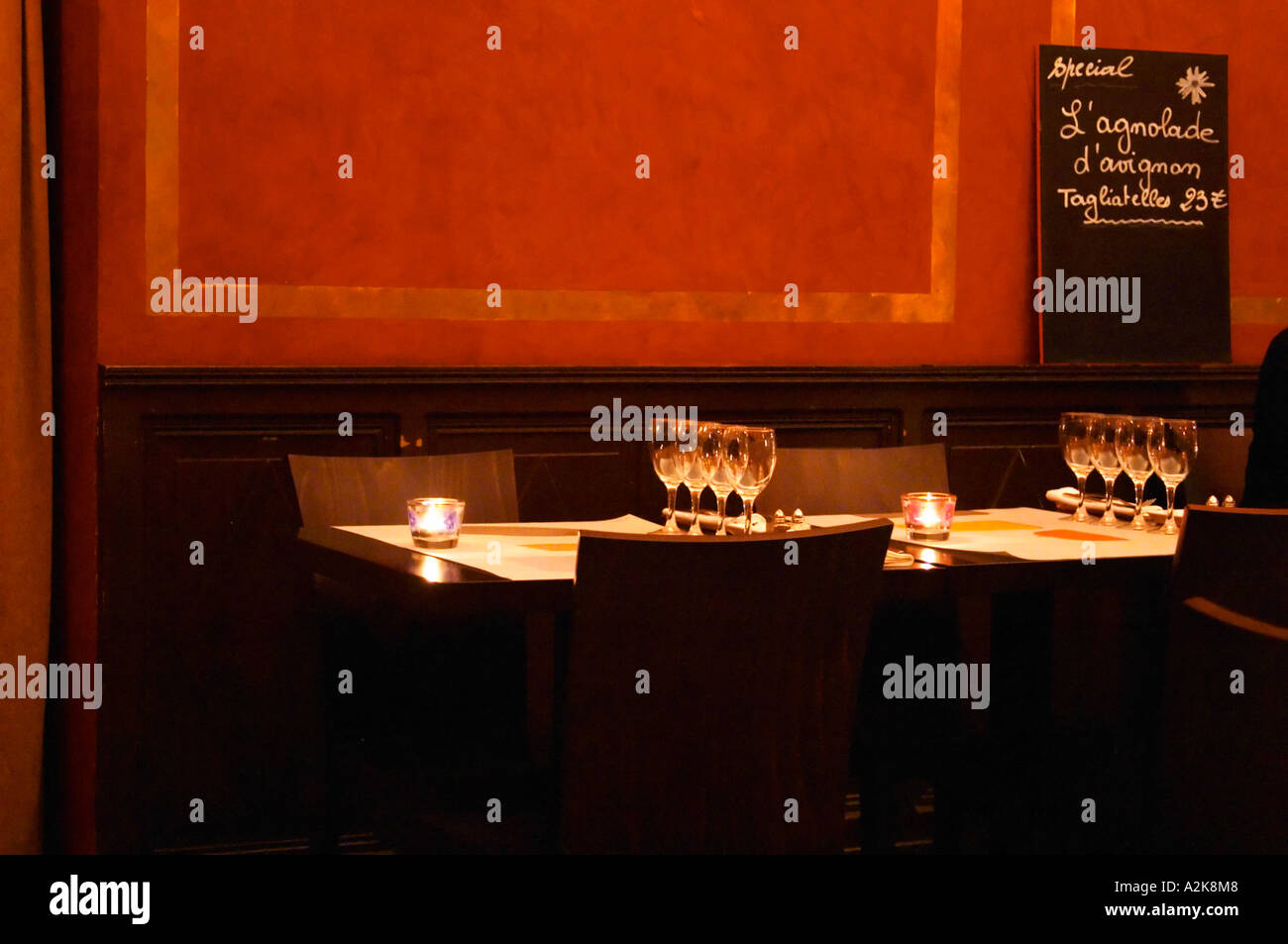 Inside the restaurant Le Mornet, tables with glasses and candels ...