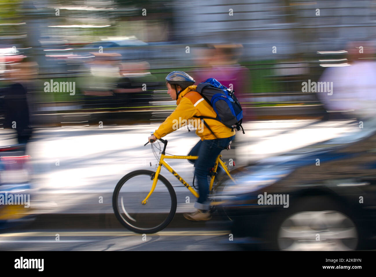 Cyclist commuting through Belfast traffic Stock Photo - Alamy