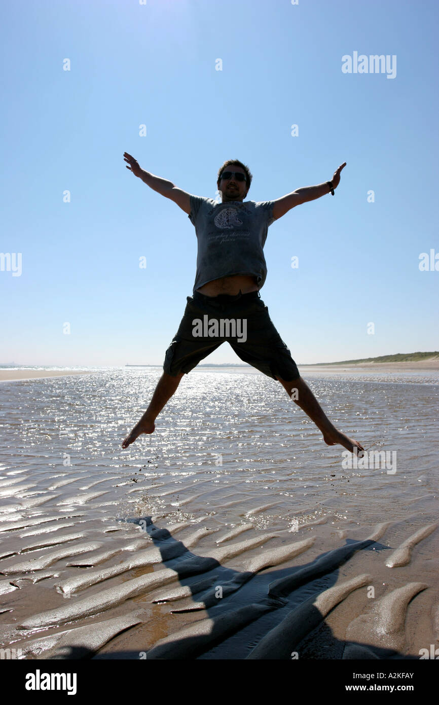 Man star jumping Stock Photo - Alamy