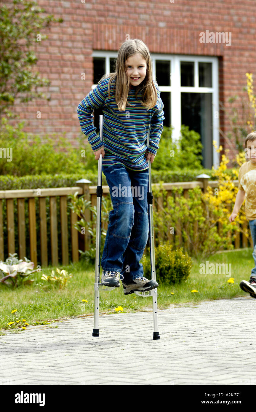 child runs on stilts Stock Photo - Alamy