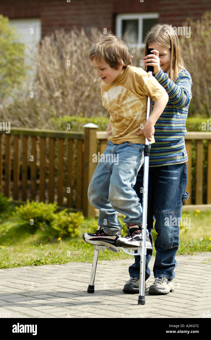 child runs on stilts Stock Photo - Alamy