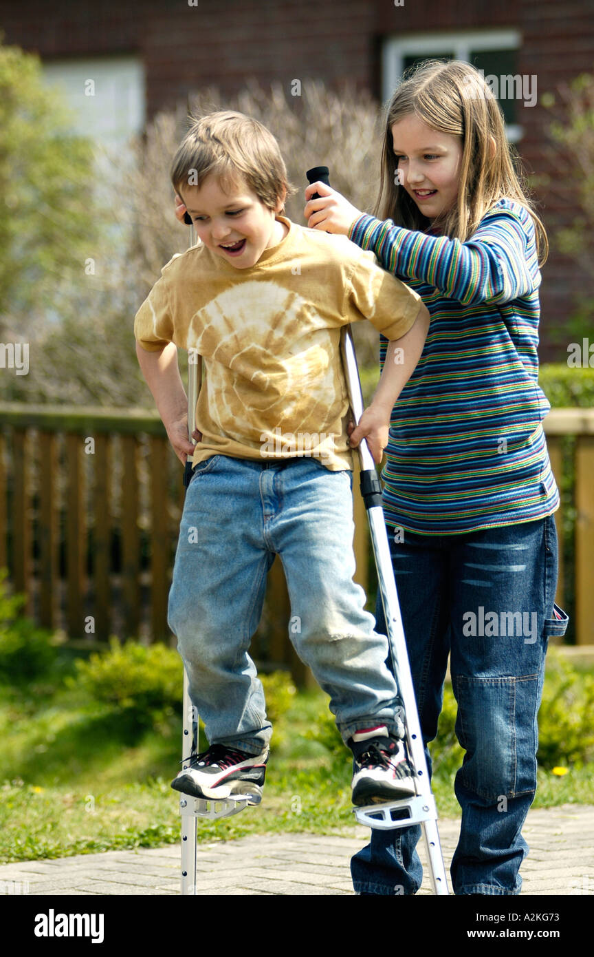 child runs on stilts Stock Photo - Alamy