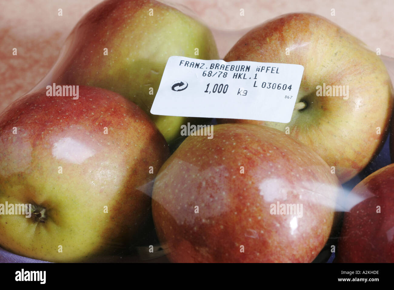 Supermarket apples packed with foil and label Stock Photo - Alamy