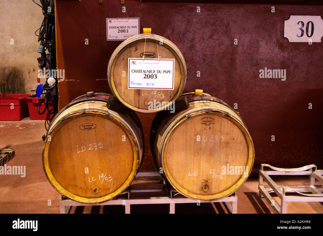 Three wooden barrels stacked in a pyramid. Sign with Chateauneuf du ...