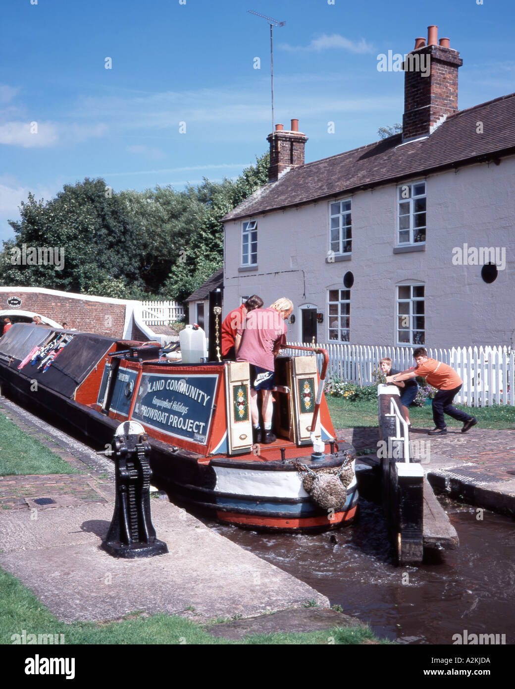 Community Project boat locking through Tixall Lock Stock Photo - Alamy