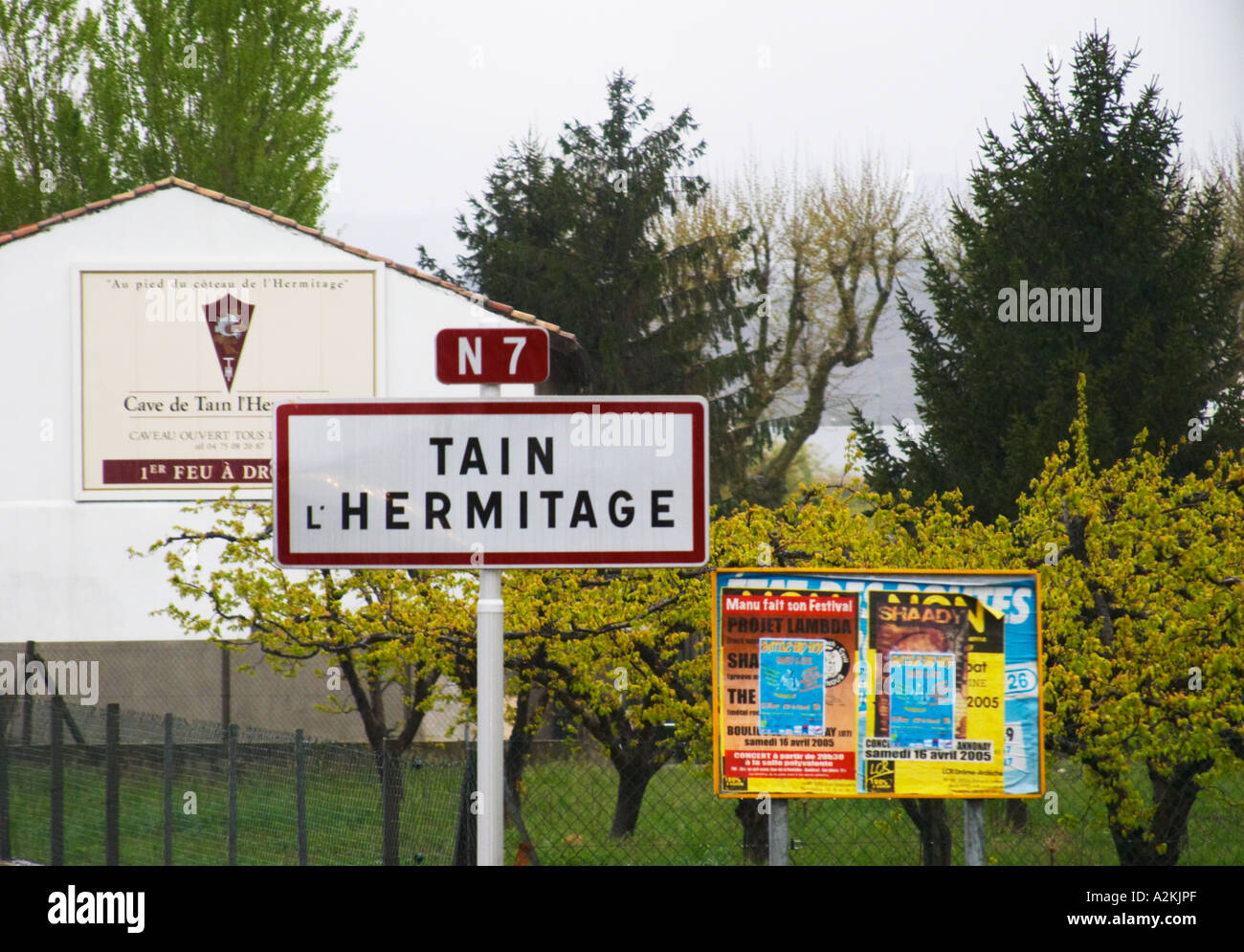 Road sign to Tain l'Hermitage and a bill board advertising the cave ...