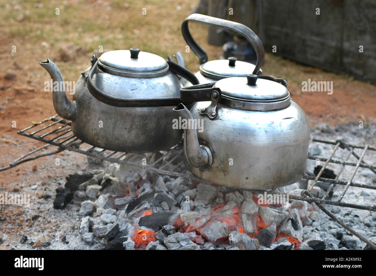 Safari kitchen tea and coffeepots on a charcoal fire Stock Photo - Alamy