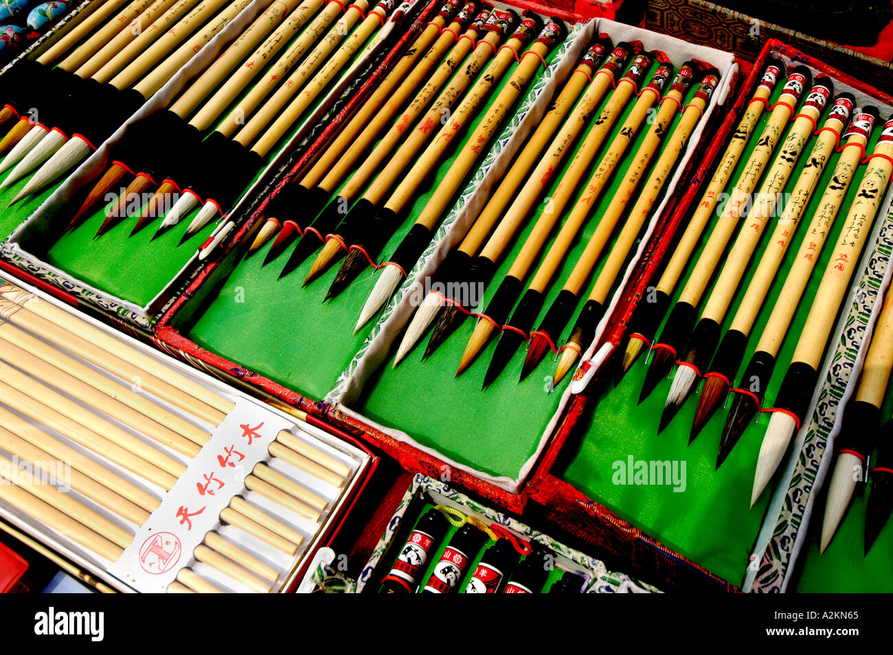 chinese writing and paintbrushes in elegant boxes at a market booth ...