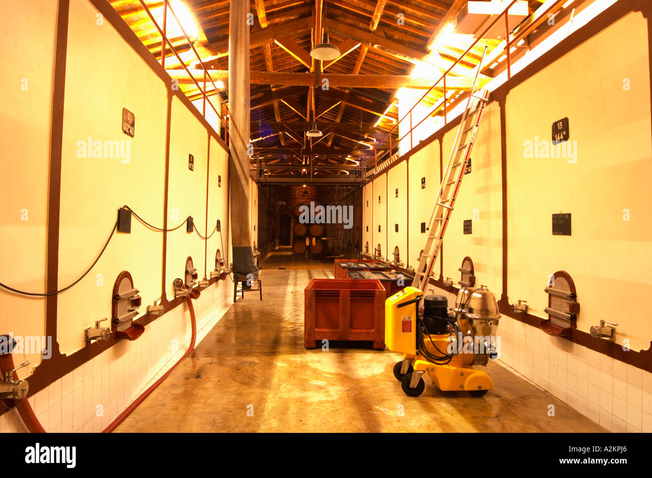 The winery with large concrete fermentation vats and a pump. Chateau de ...