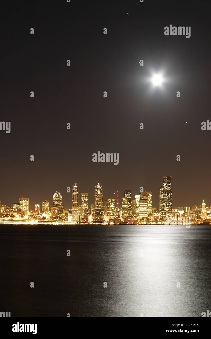Full moon rising over Seattle city skyline at night moon reflected in ...