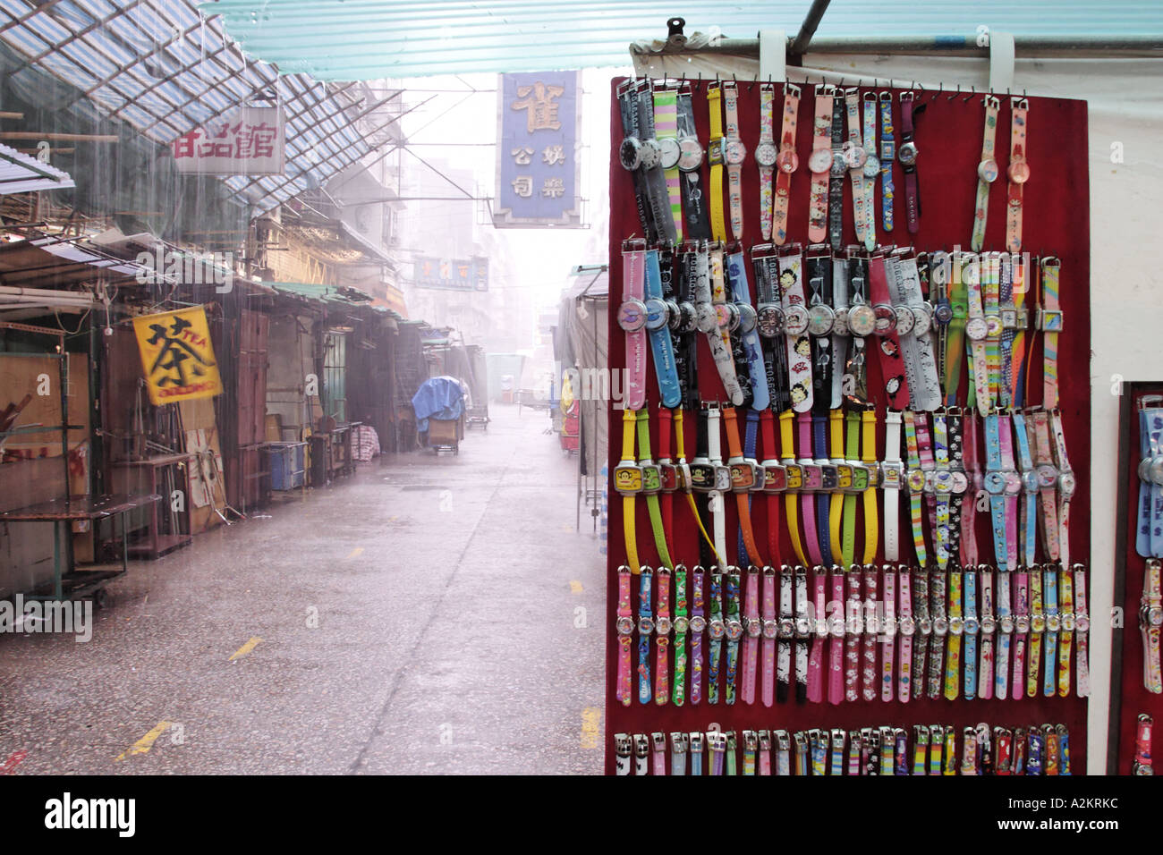Watch sellers booth on Temple Street during downpour or rain Kowloon ...