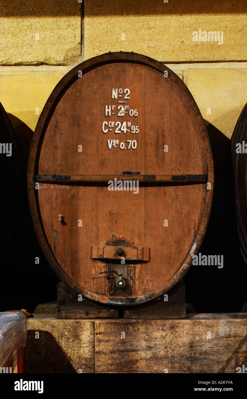 An old wooden storage vat in the winery. Domaine Viret, Saint Maurice ...
