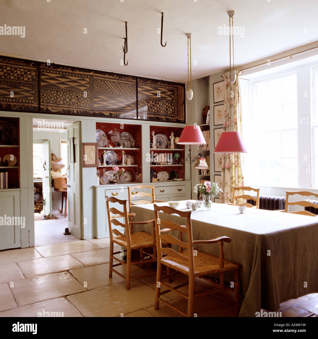 Dining room with stone slab floor and ceiling hooks Stock Photo - Alamy