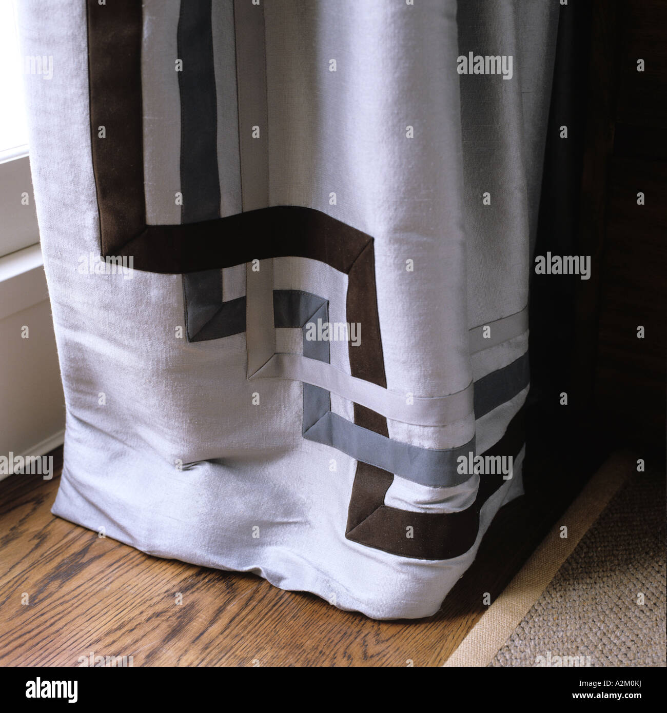 Curtain edge just reaching wooden floor Stock Photo - Alamy