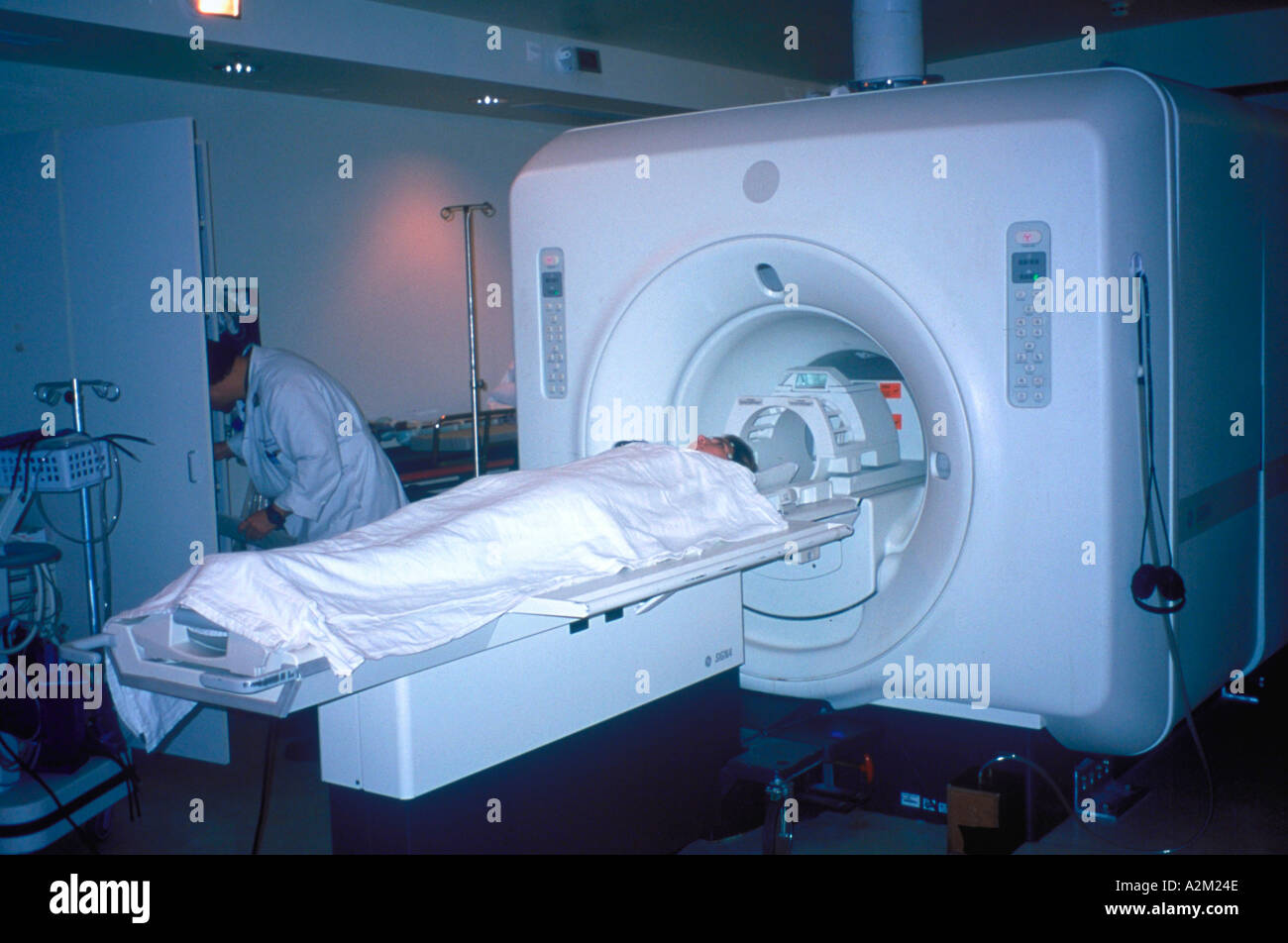 A patient being placed into an MRI magnetic resonance imaging machine ...