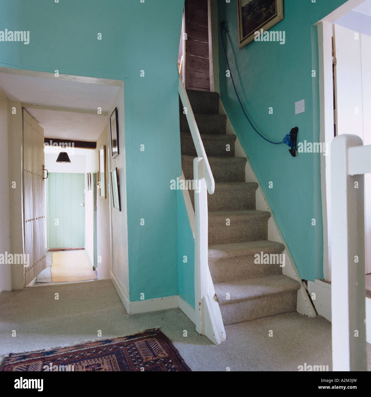 Turquoise painted hallway with staircase in Georgian farmhouse Stock ...