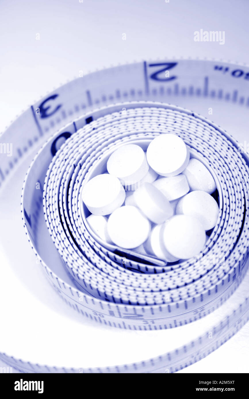 Measuring tape and pills Stock Photo - Alamy