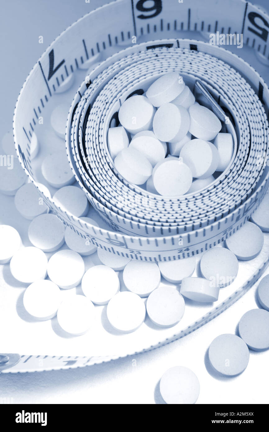 Measuring tape and pills Stock Photo - Alamy
