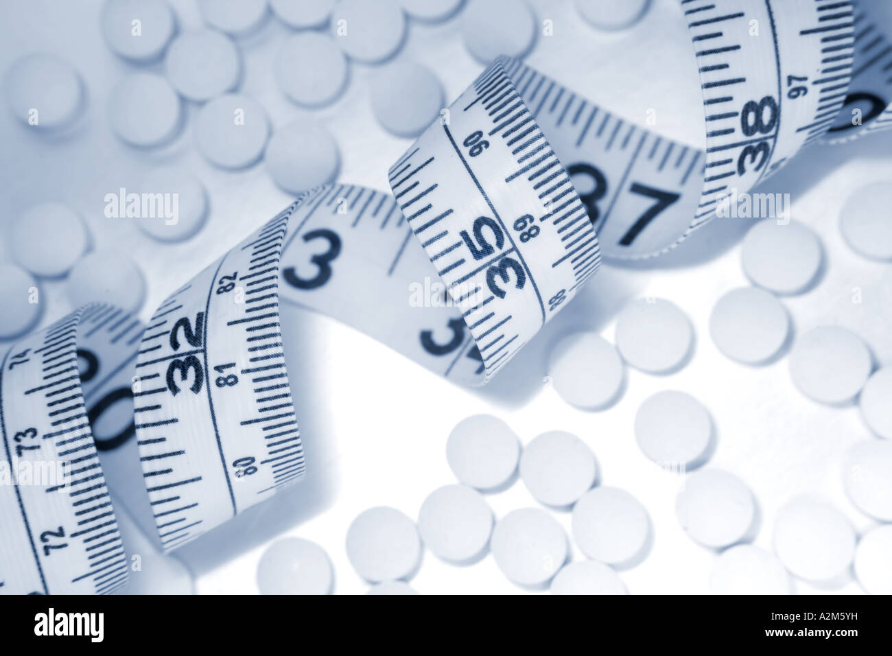 Measuring tape and pills Stock Photo - Alamy
