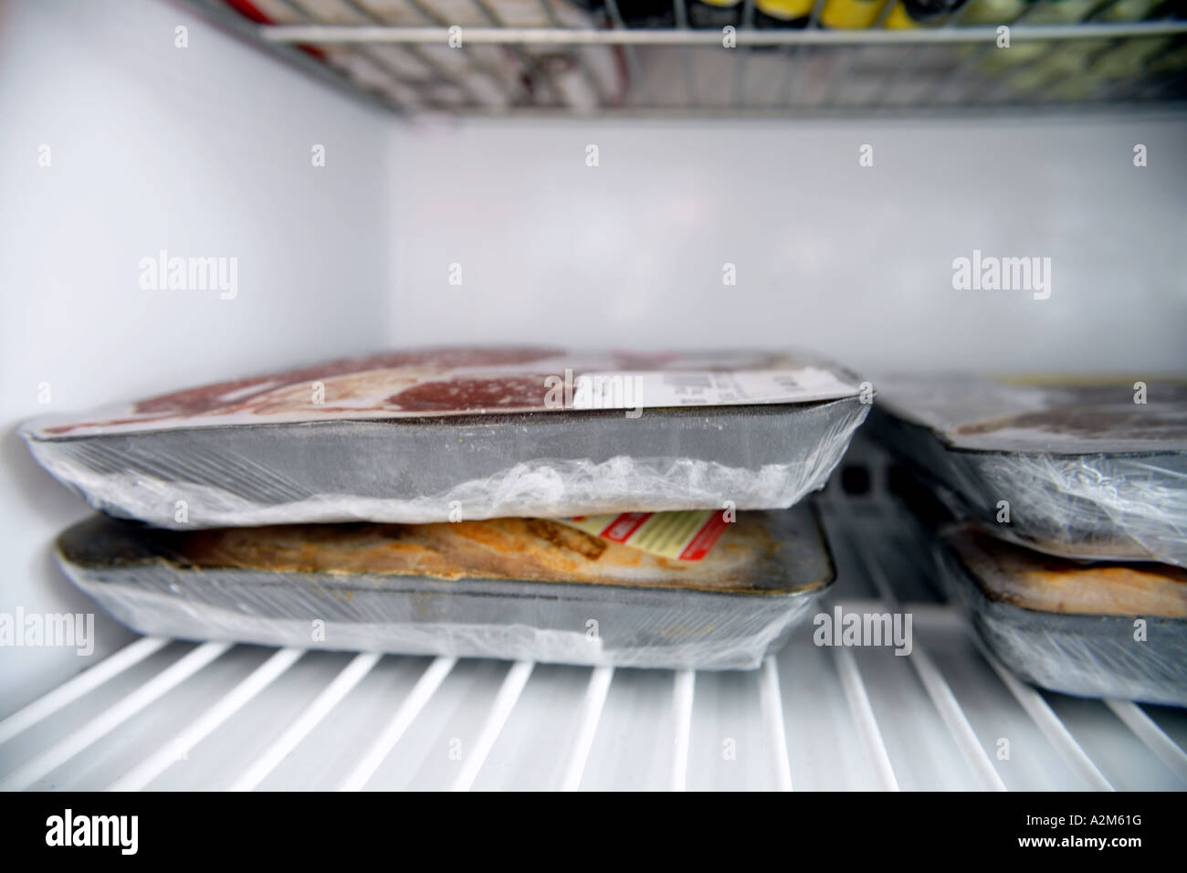 Frozen food in trays on shelf of freezer Stock Photo - Alamy