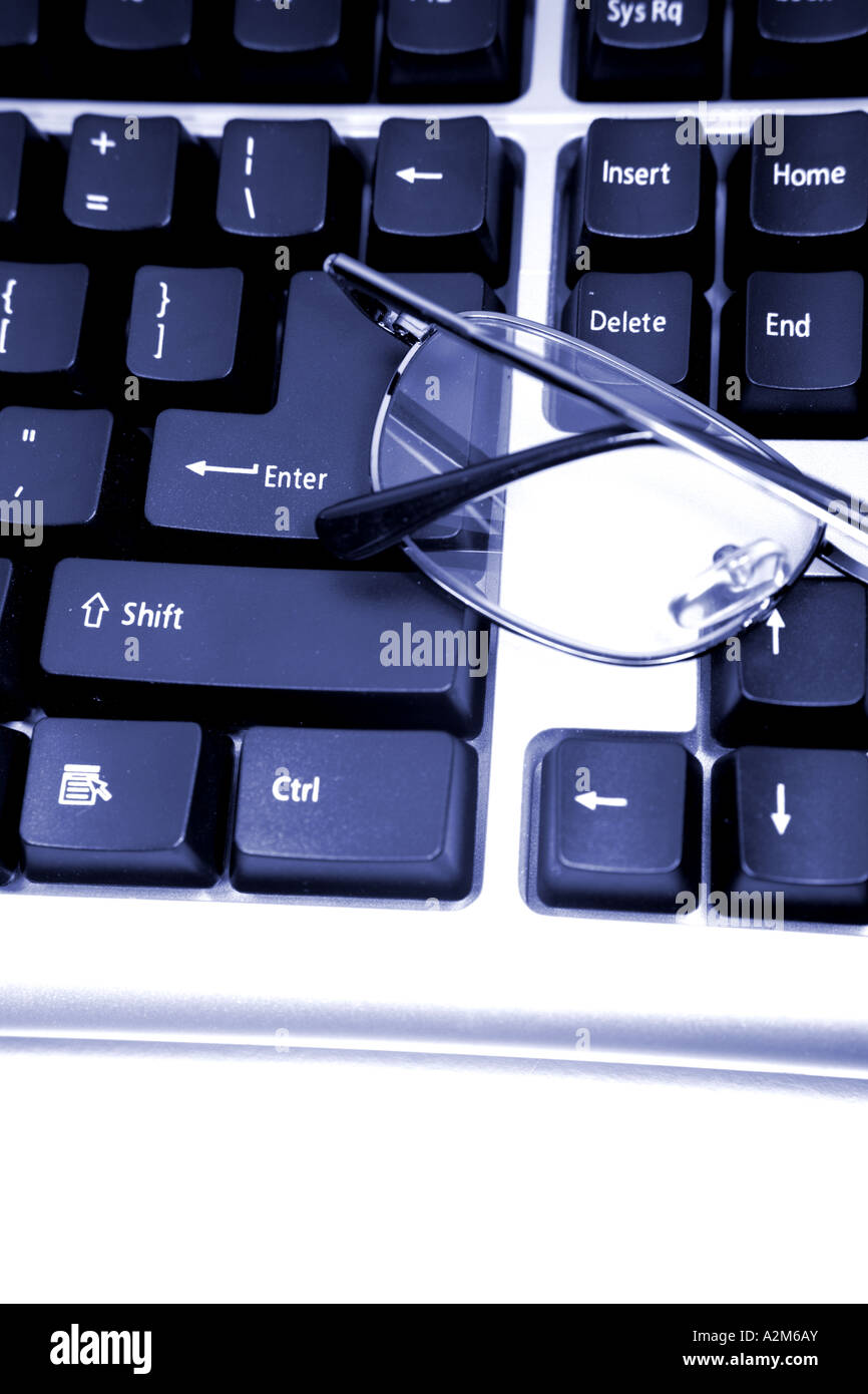 Eyeglasses on computer keyboard Stock Photo - Alamy