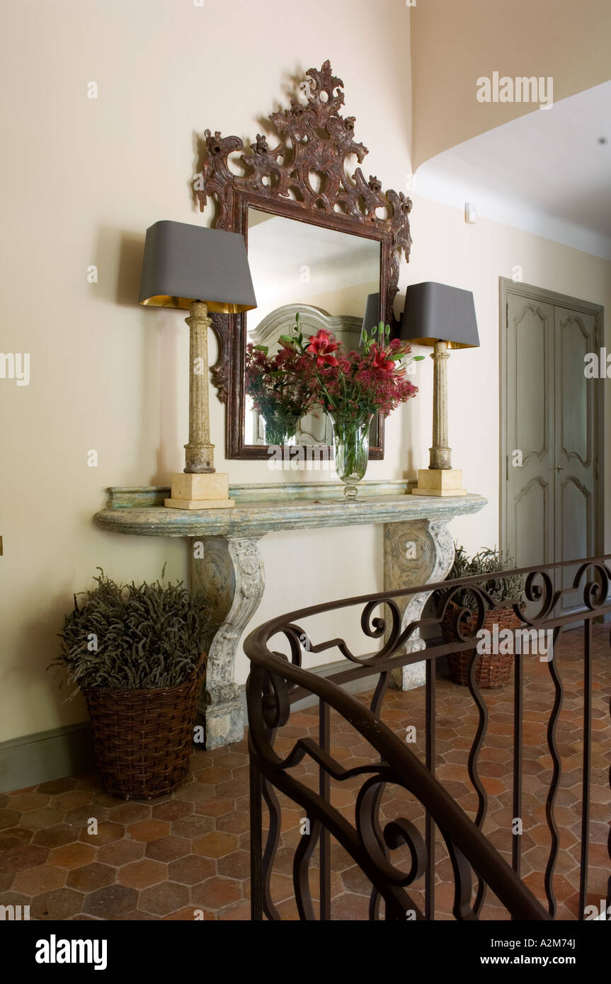 Matching lamps on hallway marble table below mirror Stock Photo - Alamy
