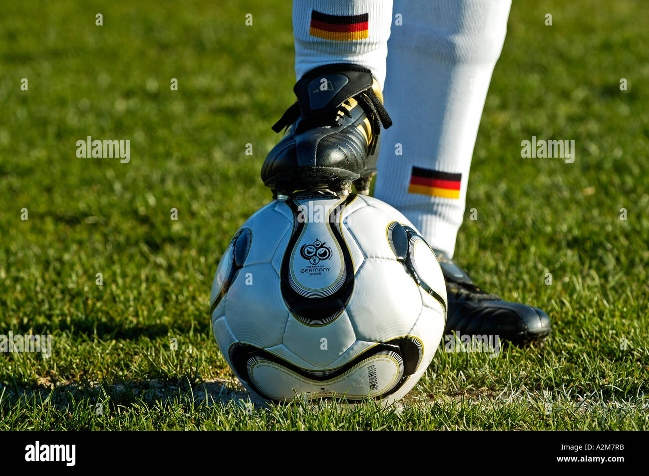 the legs of a german national soccer player and the official ball of ...