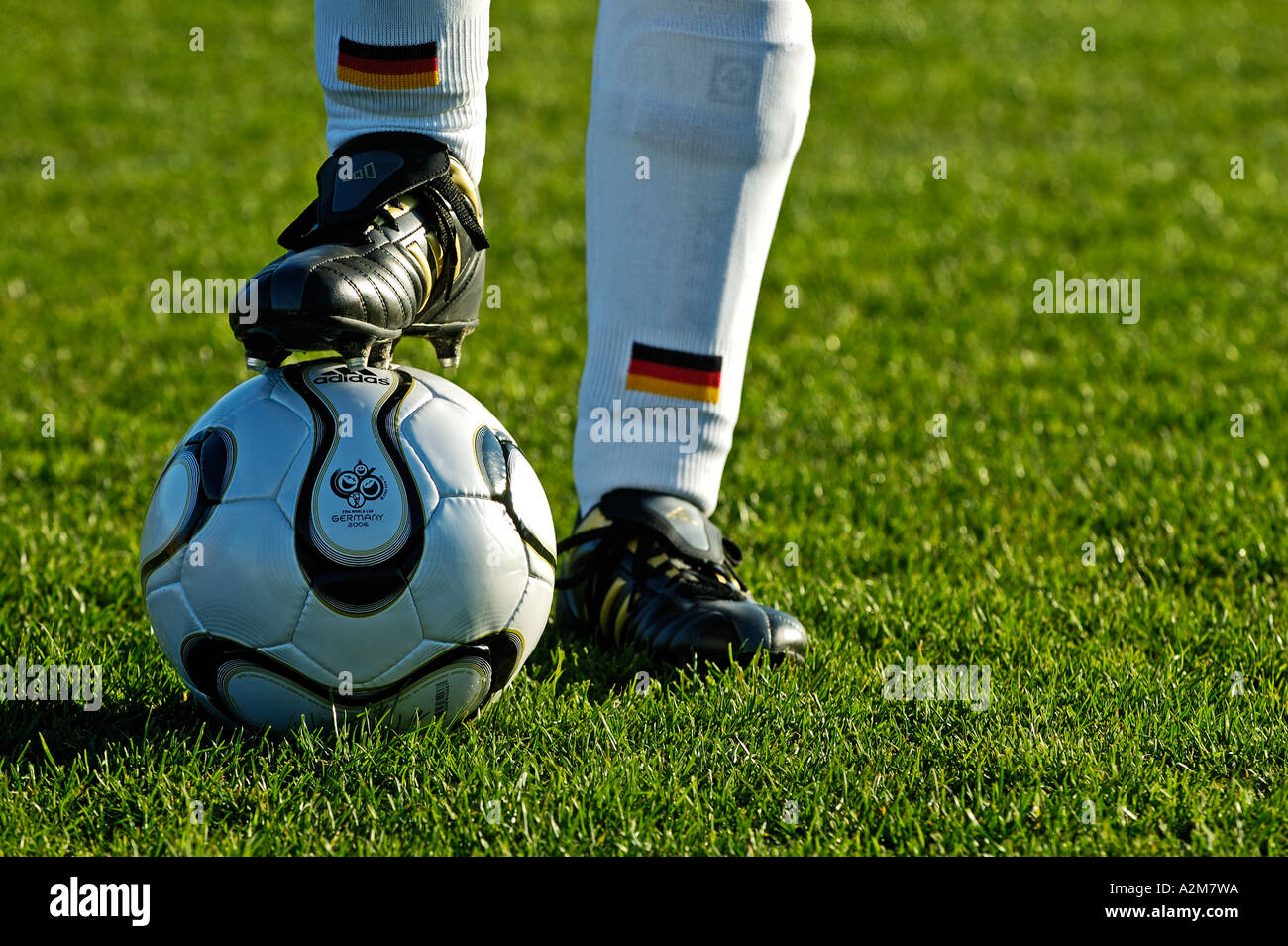 the legs of a german national soccer player and the official ball of ...