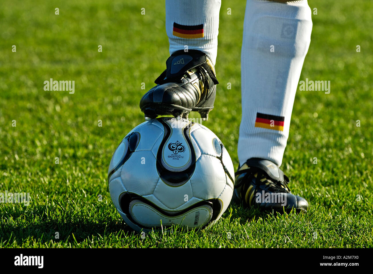 the legs of a german national soccer player and the official ball of ...