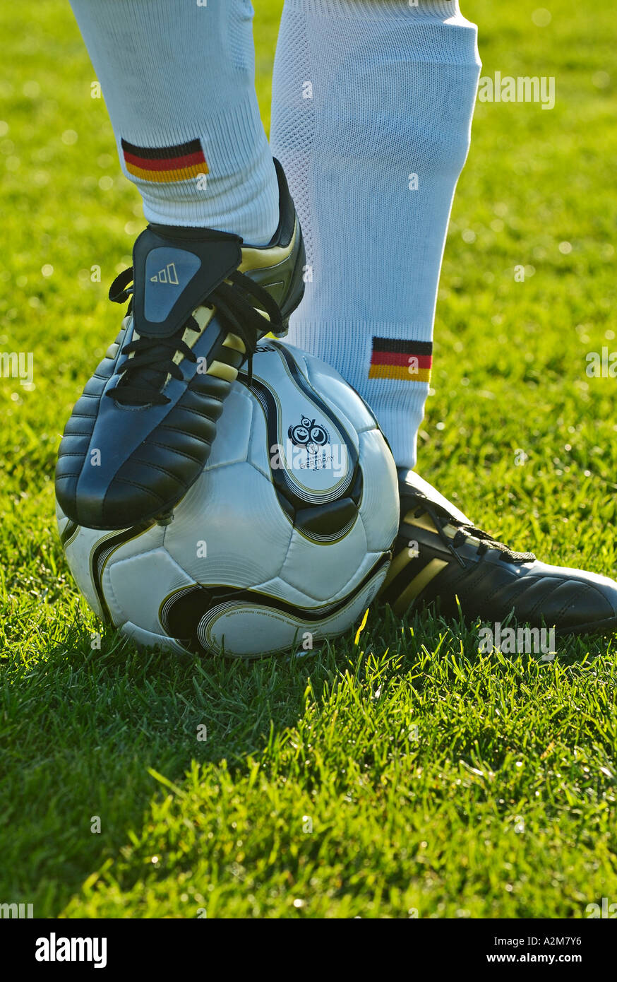 the legs of a german national soccer player and the official ball of ...