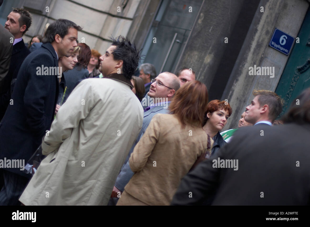group of people waiting in front of a door Stock Photo - Alamy