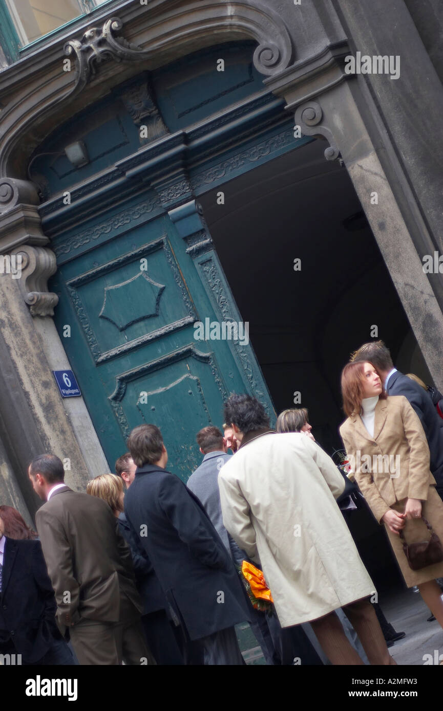group of people waiting in front of a door Stock Photo - Alamy