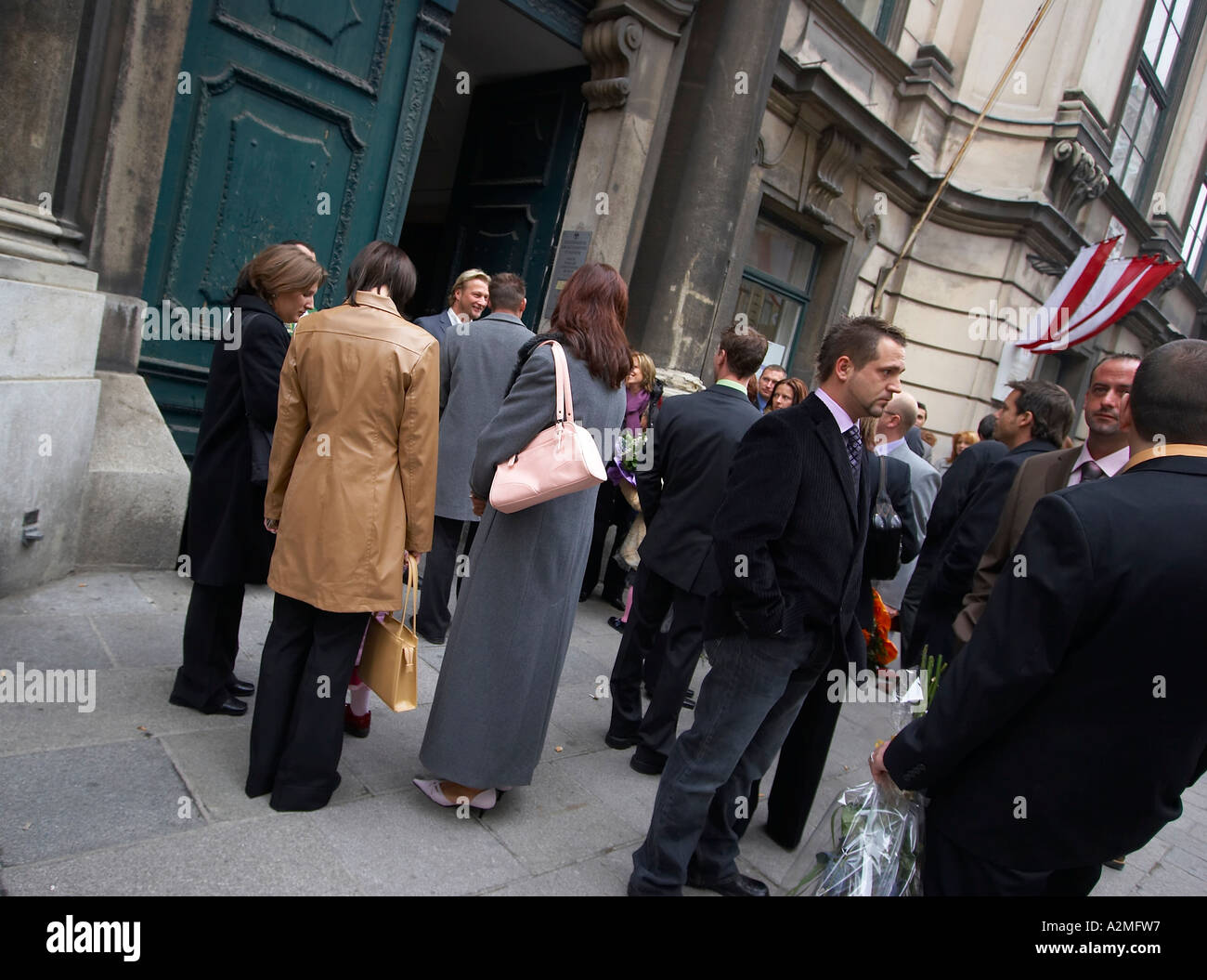 group of people waiting in front of a door Stock Photo - Alamy