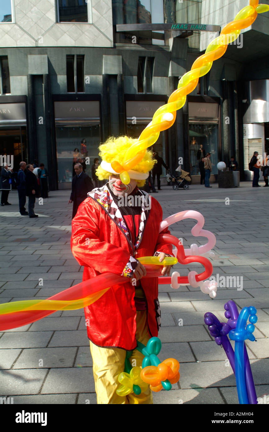 A street clown makes bendy toys from balloons in Vienna's city center ...