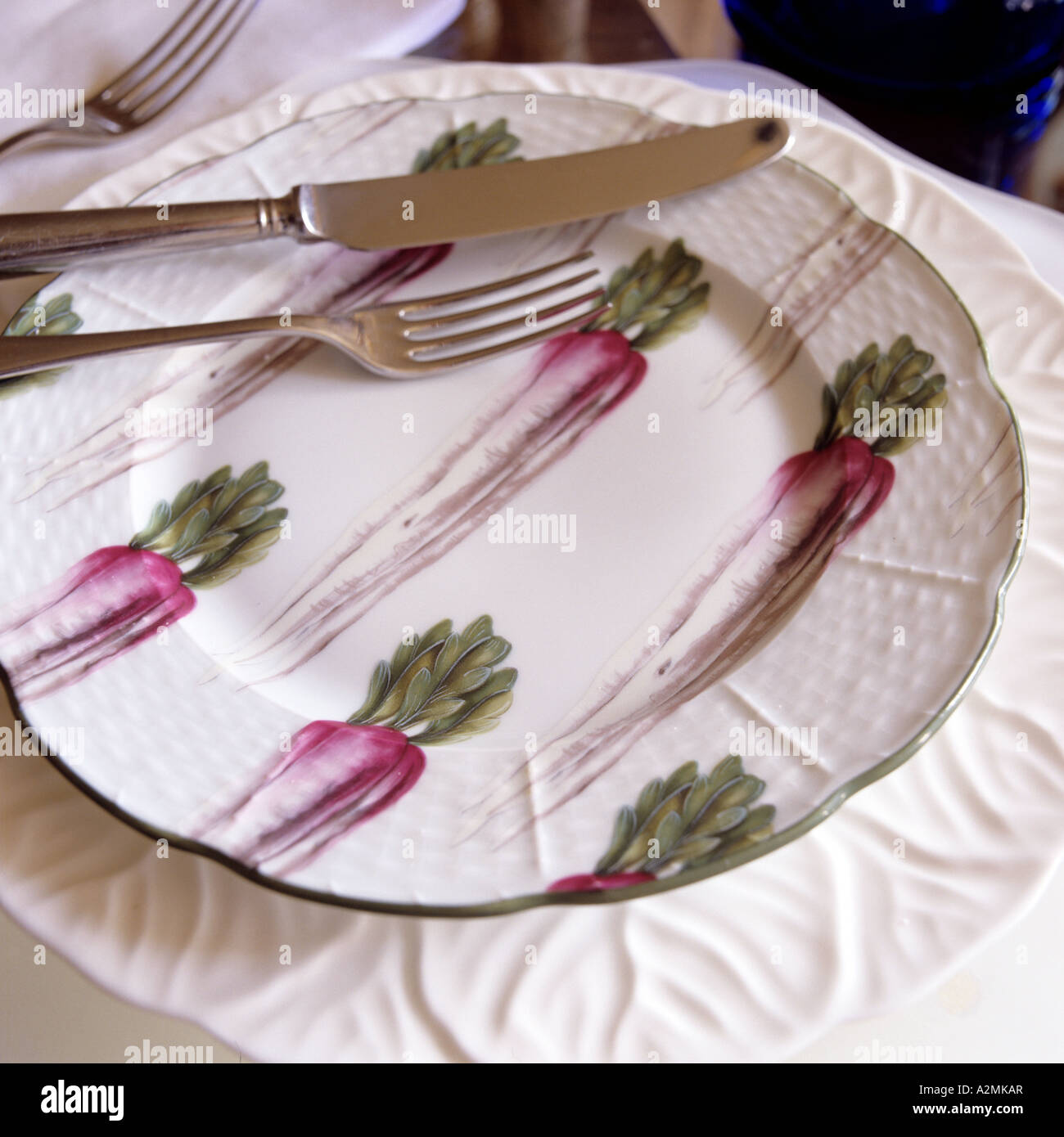 Plate with radish design and cutlery Stock Photo - Alamy