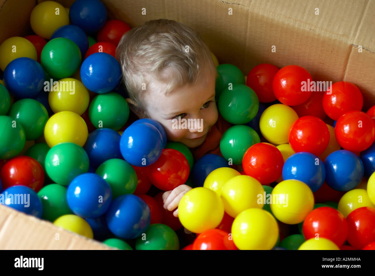 baby sitting in box with hundreds of colorful plastic balls Stock Photo ...
