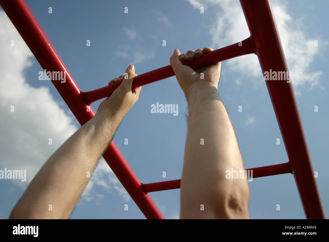 Holding onto monkey bars Stock Photo - Alamy