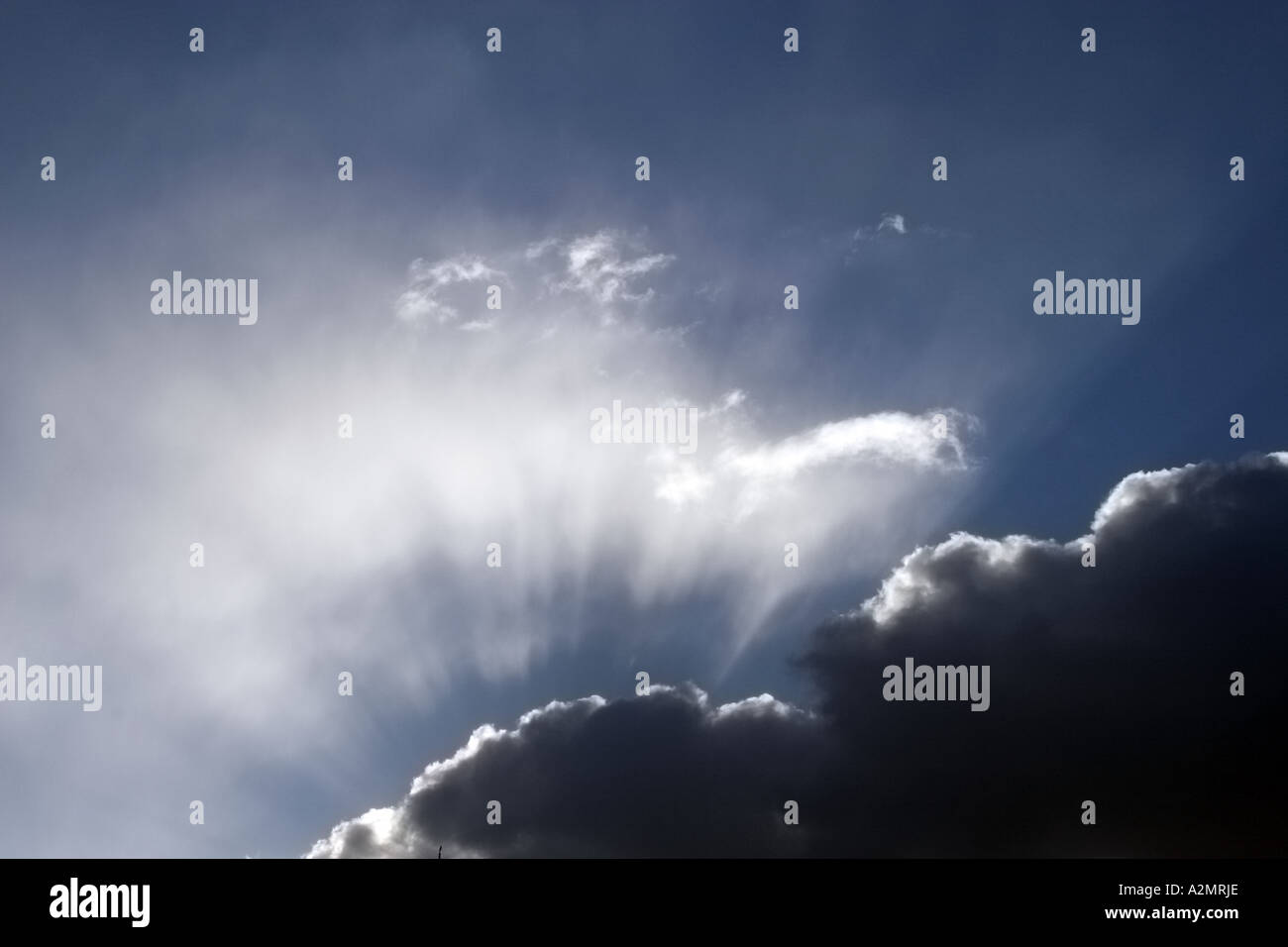 Sunlight through clouds Stock Photo - Alamy